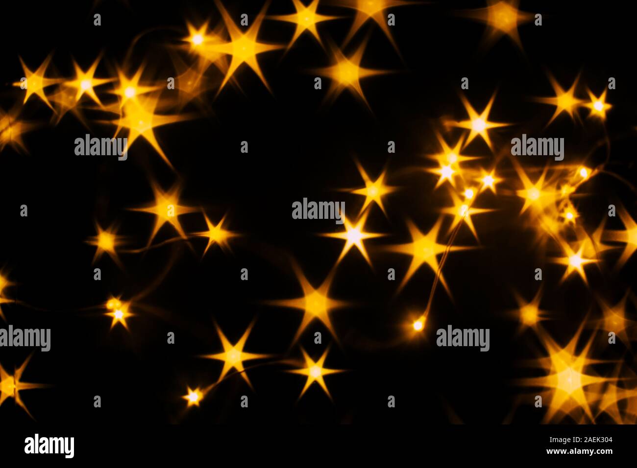 Splash of golden stars on black background Stock Photo - Alamy