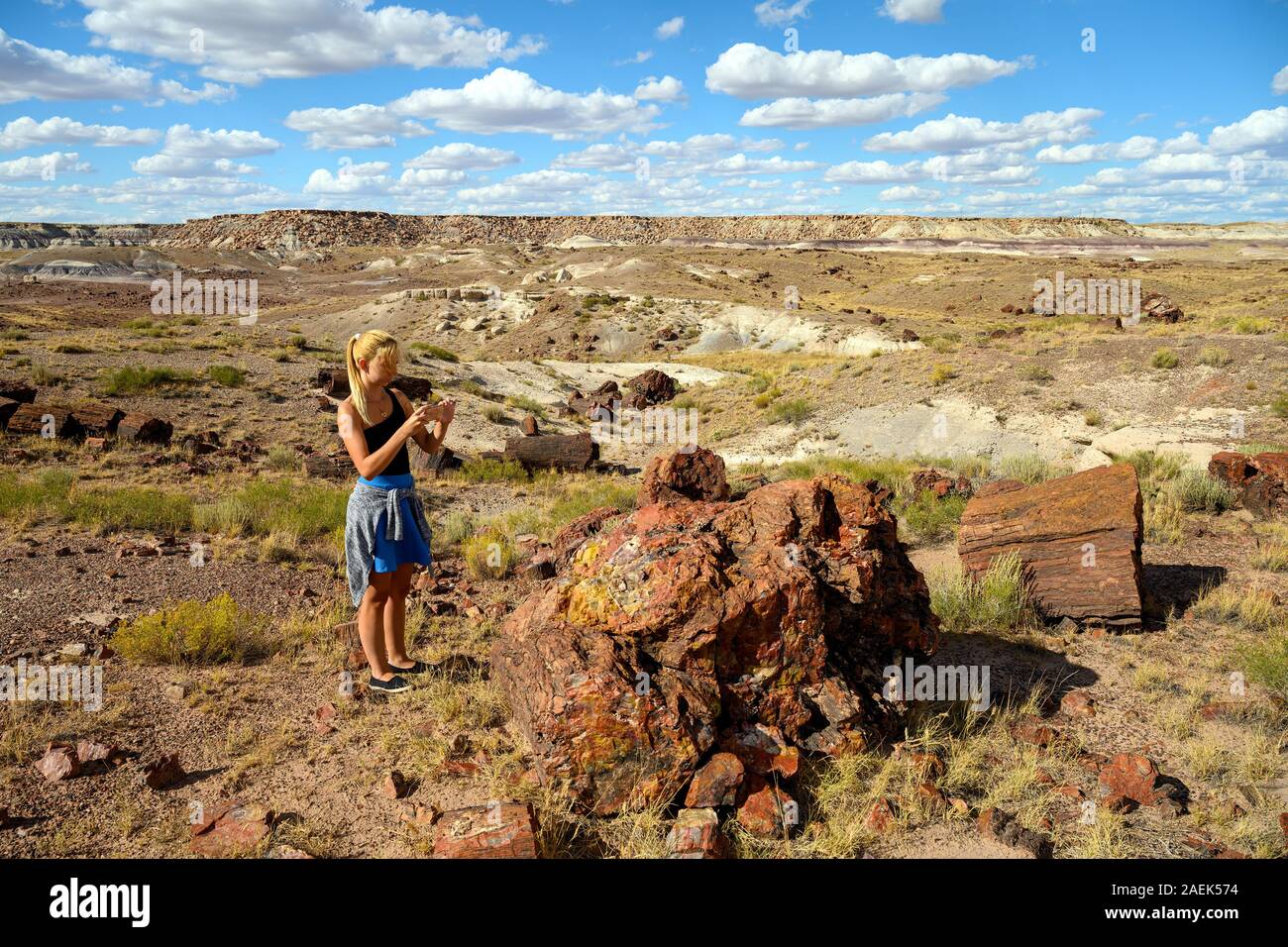 Female tourist admiring the view in and taking photos with her cell ...