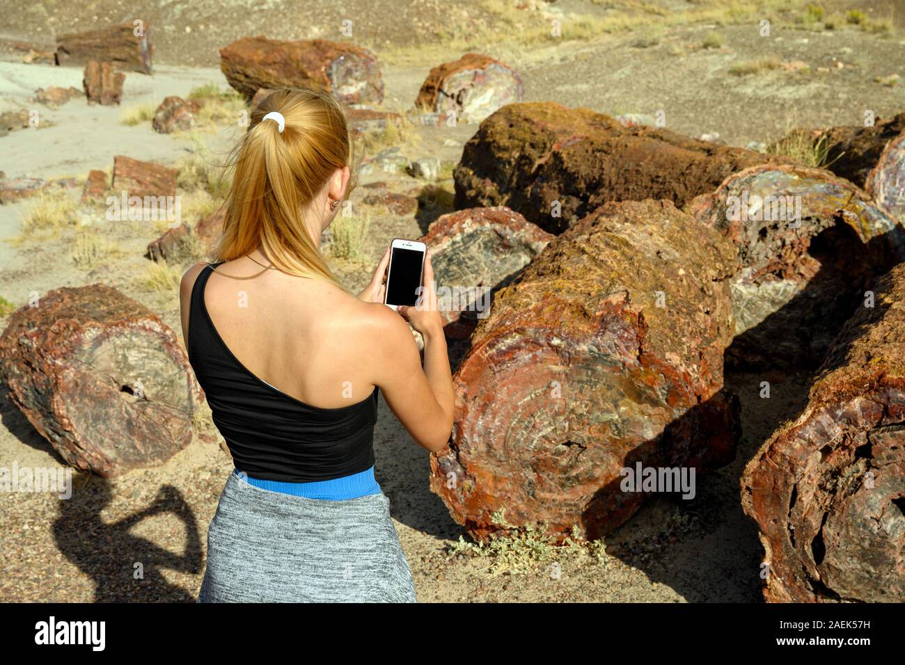 Female tourist admiring the view in and taking photos with her cell ...