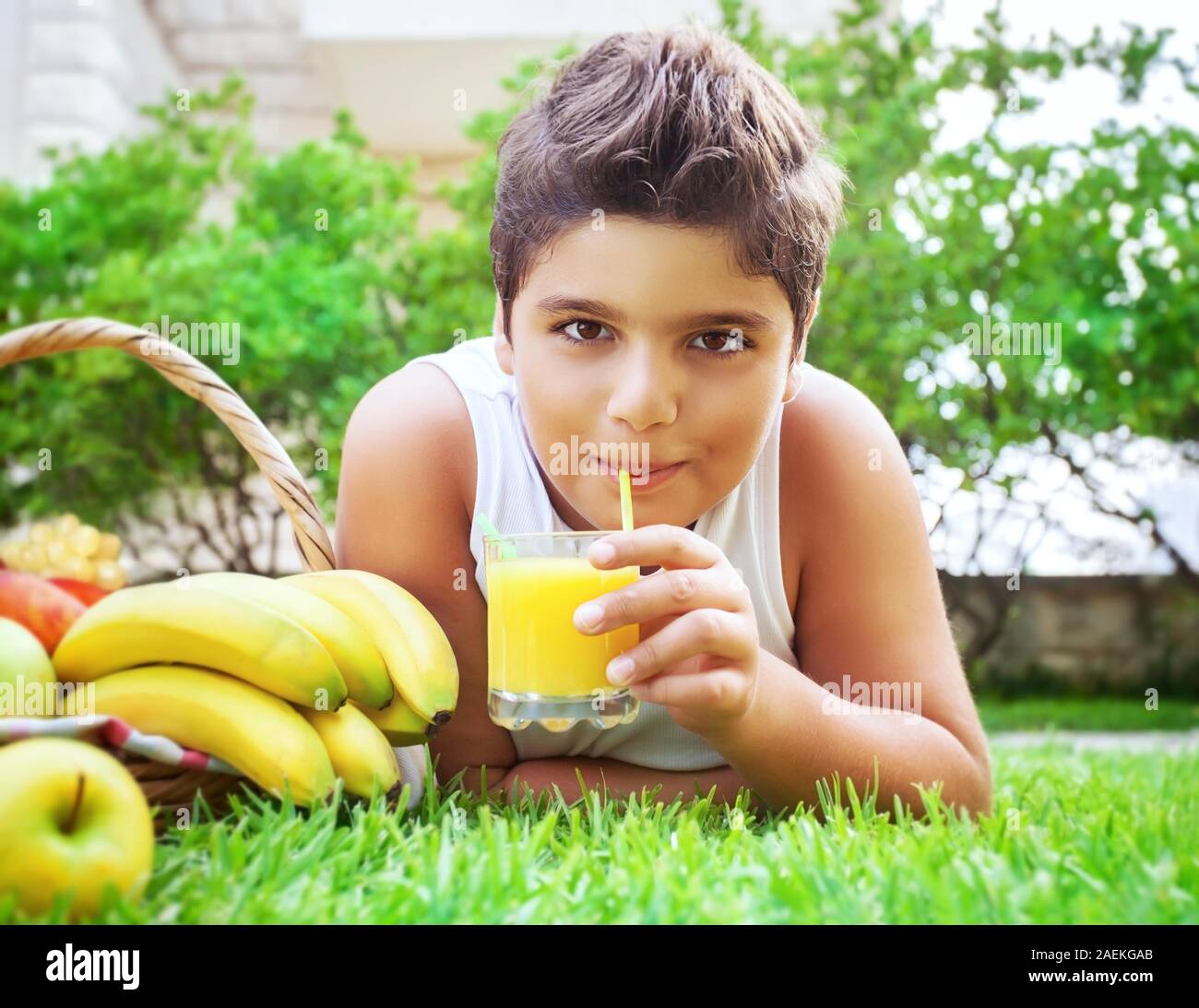 Happy boy drinking juice Stock Photo - Alamy