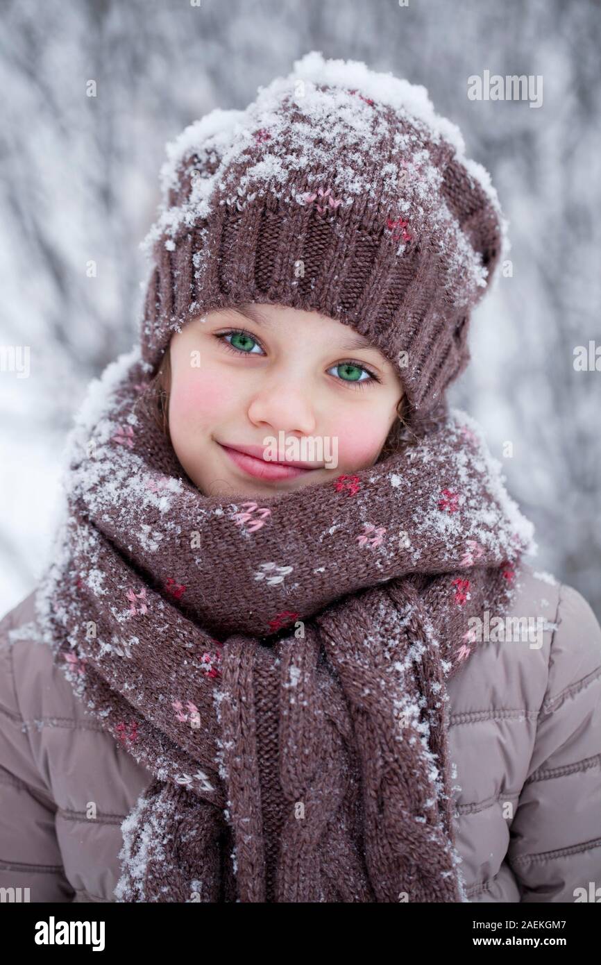 Girl with a snow-covered wool cap in winter Stock Photo - Alamy