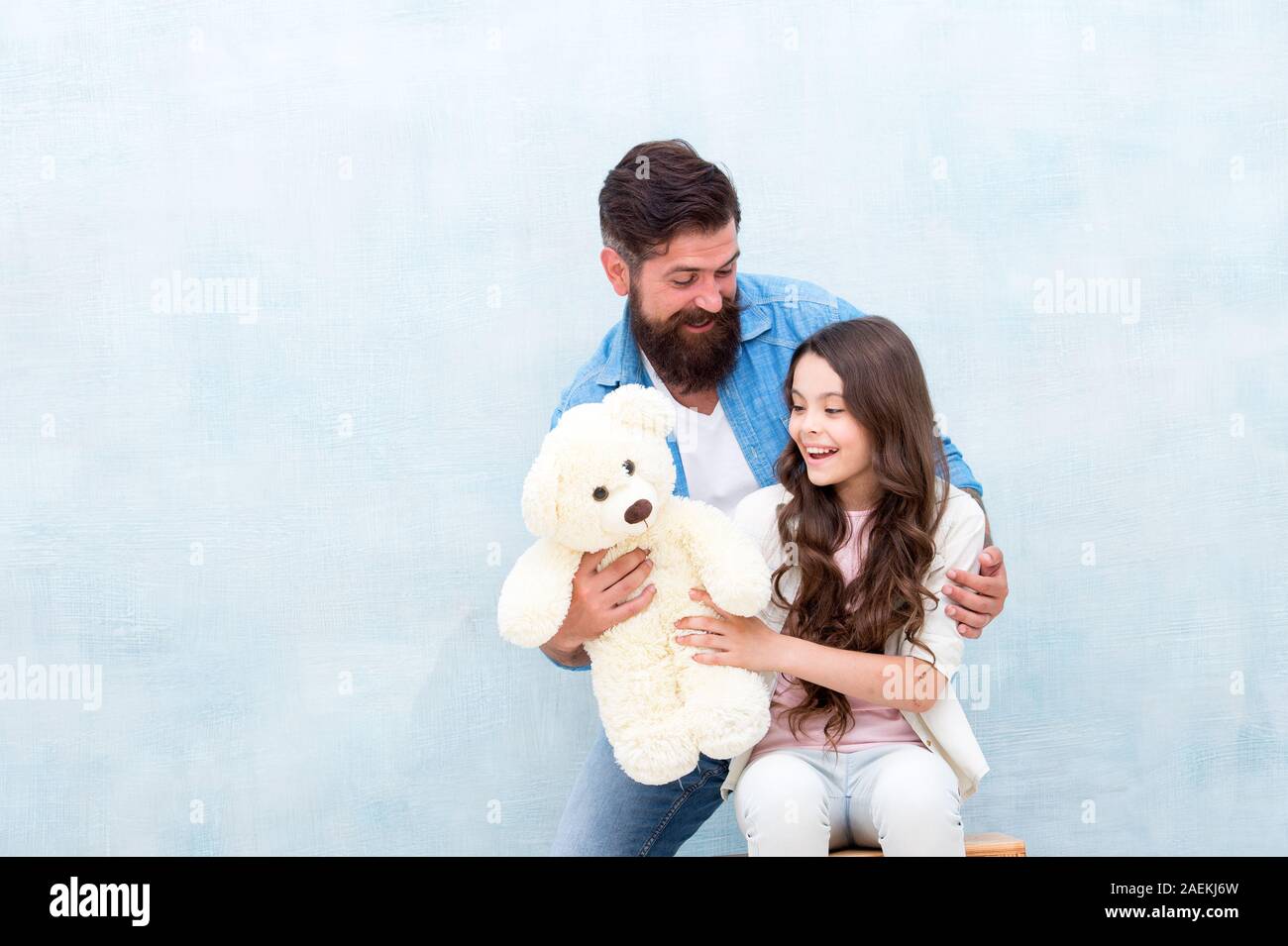 Giving soft toy teddy bear. Lovely father and kid. Father and daughter ...