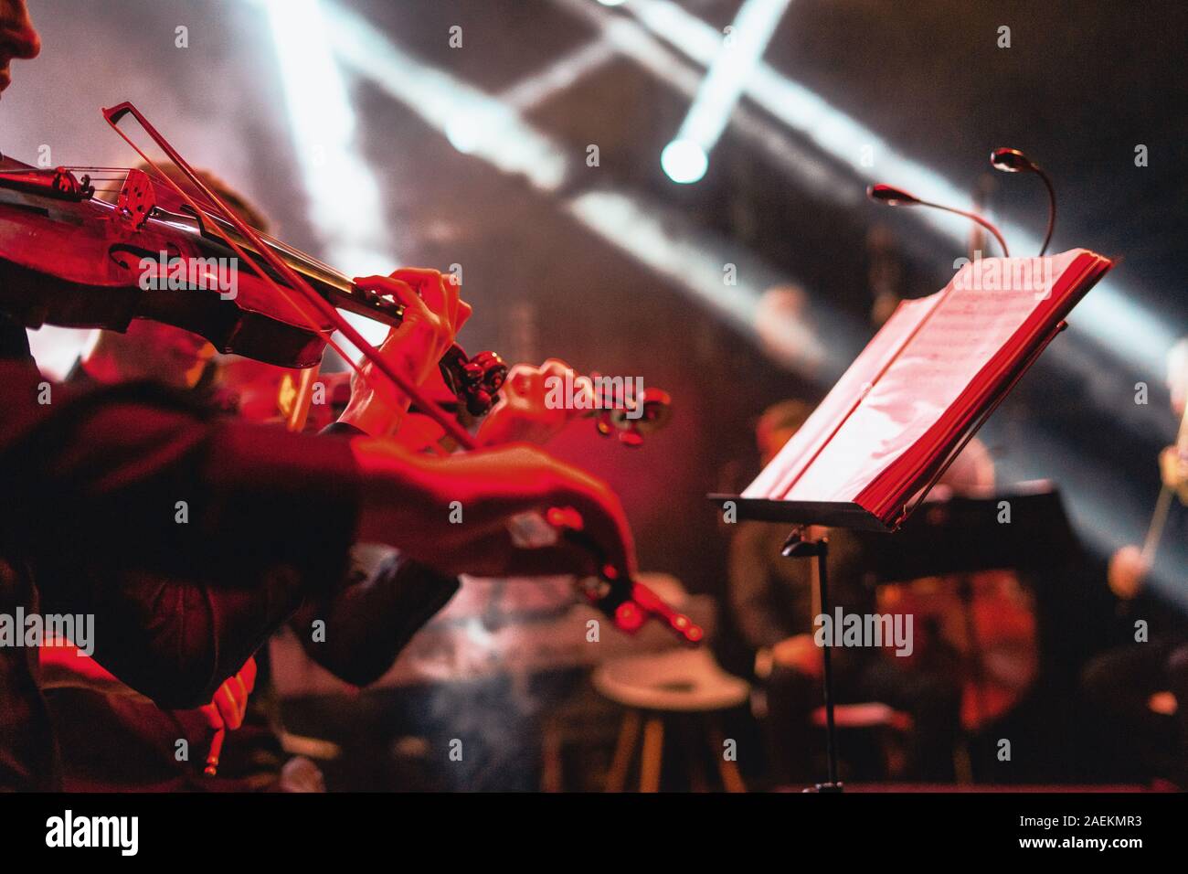 Red colored violin concert at bright rock stage Stock Photo - Alamy