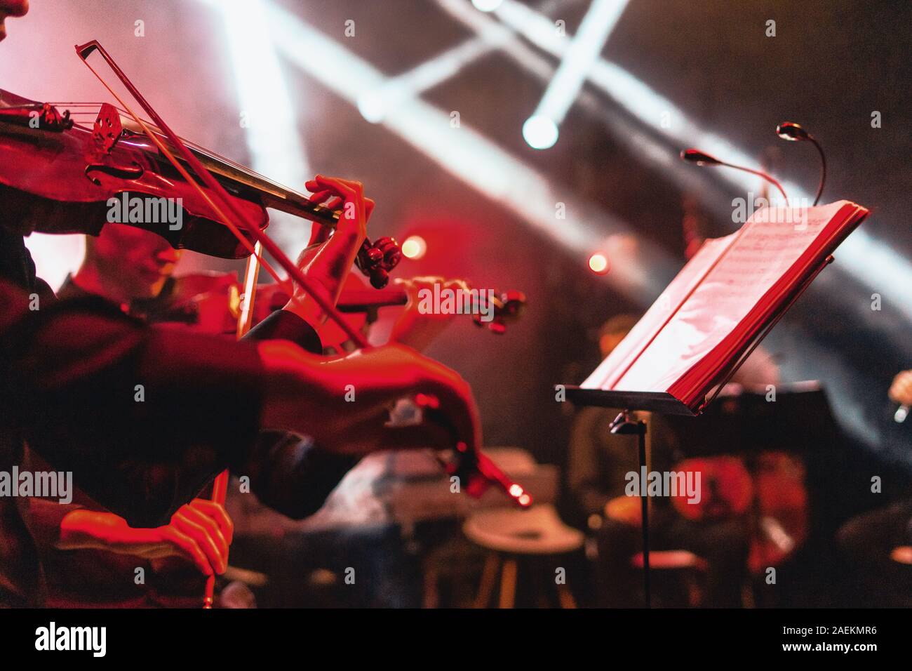 Red colored violin concert at bright rock stage Stock Photo - Alamy