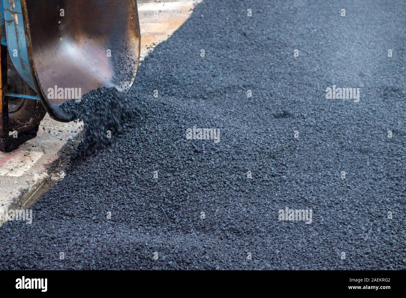 blacktop tarmac street repair fresh blacktop poured from a wheelbarrow ...