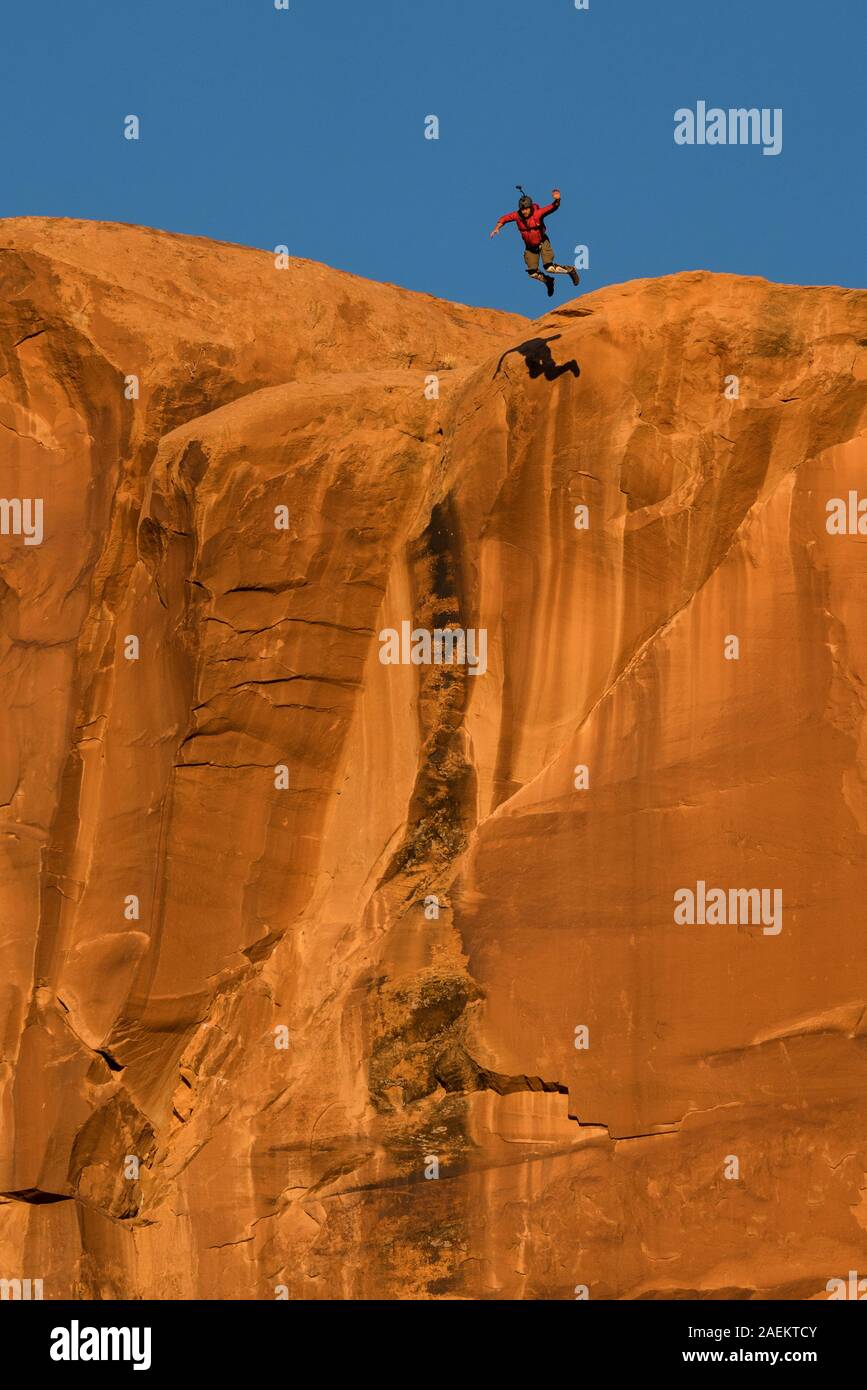 A BASE jumper leaps off the top of the 400 foot vertical face of the ...