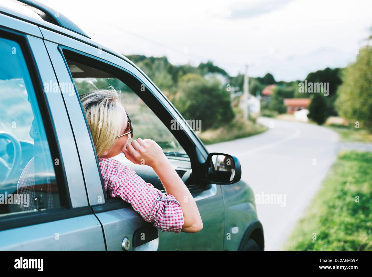 Summer holiday roadtrip travel to countryside. Young hipster blond ...