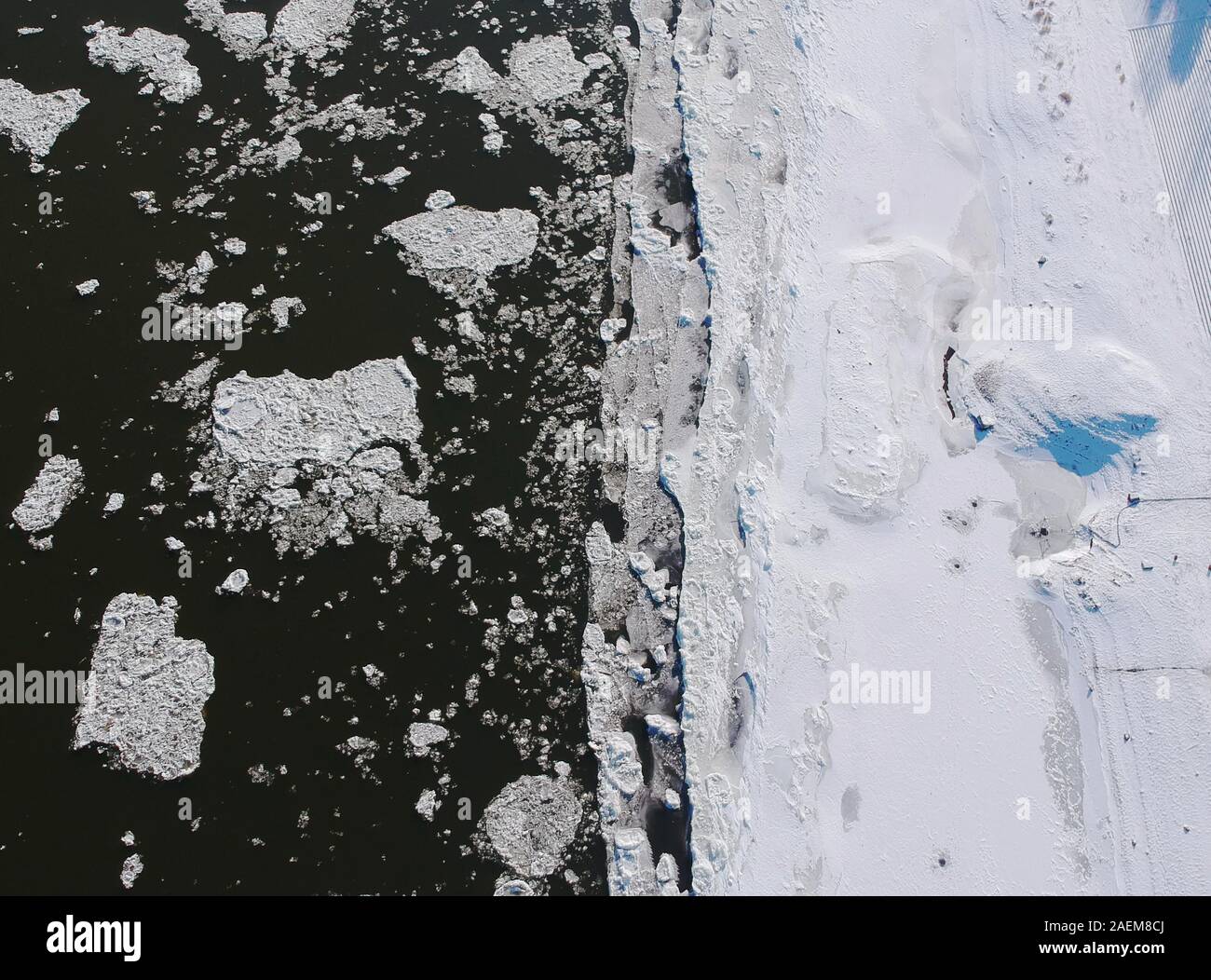 An aerial view of various ice with different shapes and areas floating ...