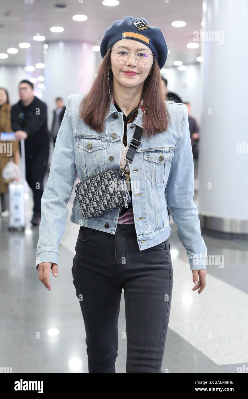 Chinese singer and actress Tan Weiwei arrives at a Beijing airport ...