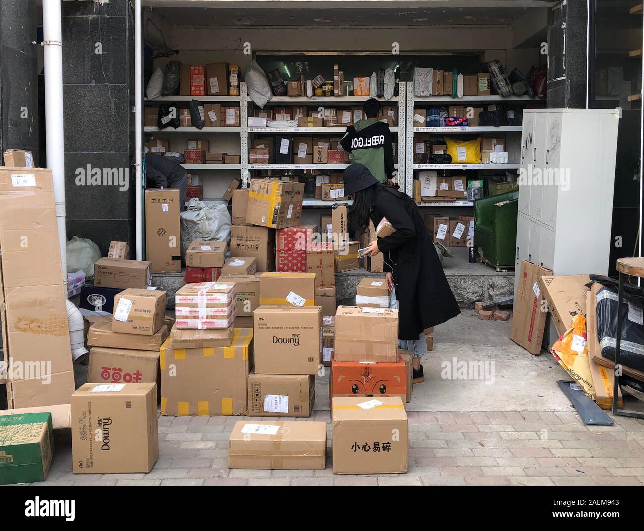 A college student searches for her Double Eleven parcel at the school ...