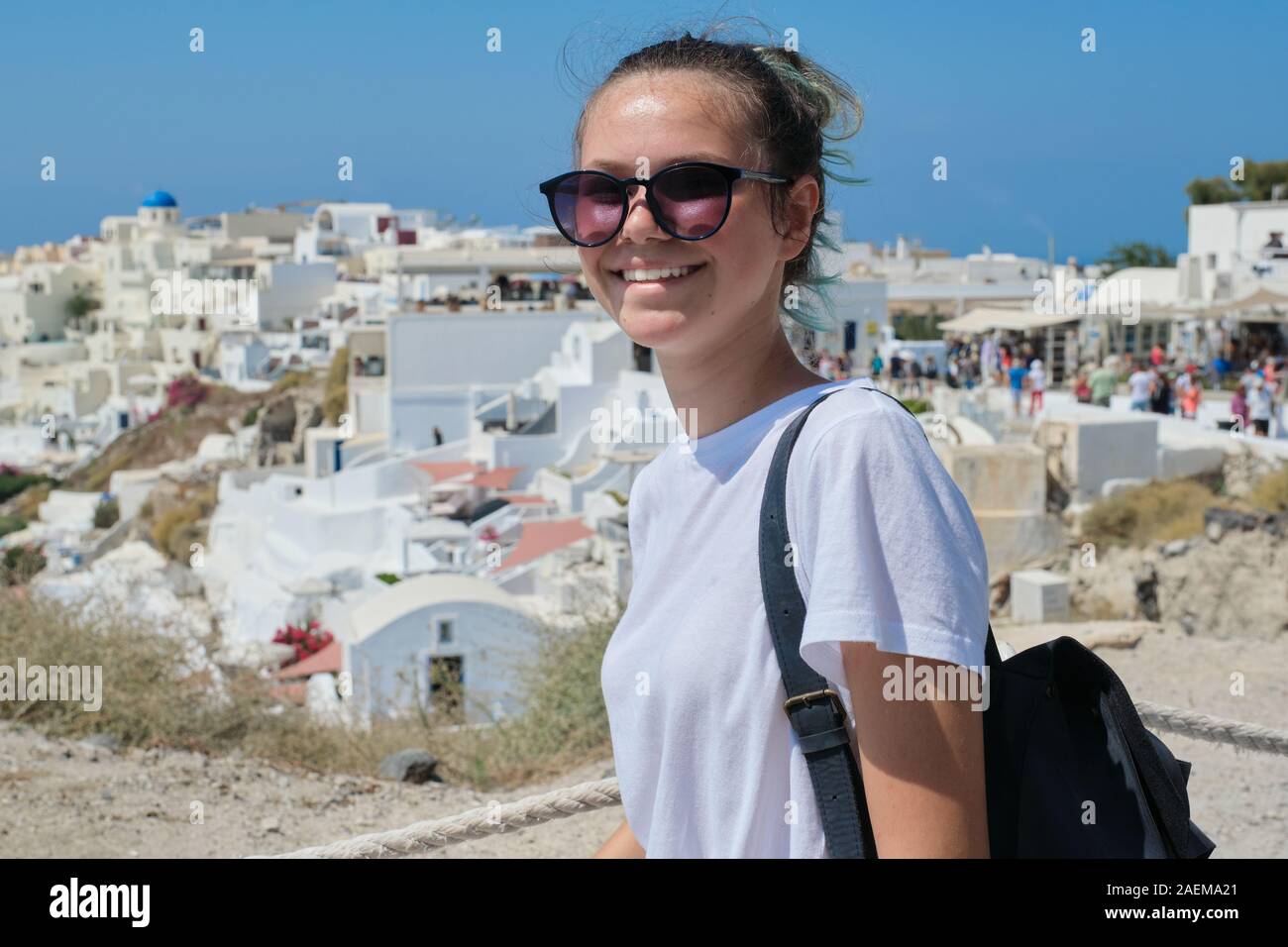 Smiling teenager posing on the island Santorini, from Oia, Greece Stock ...