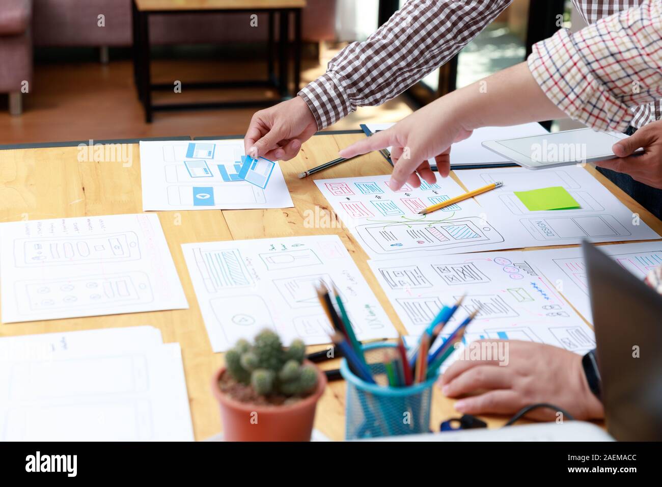 Graphic designers work together with UX UI designer planning ...