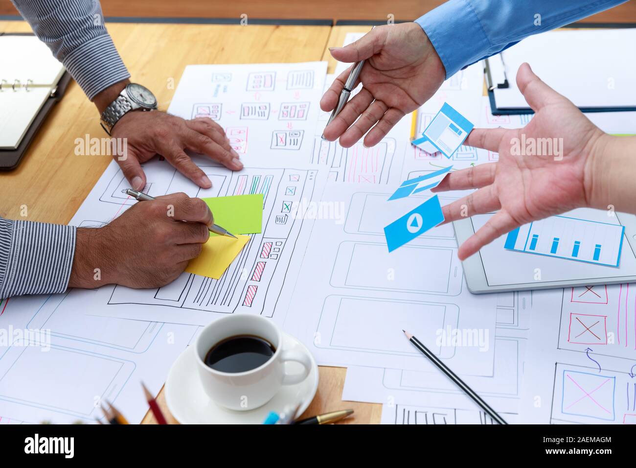 Graphic designers work together with UX UI designer planning ...