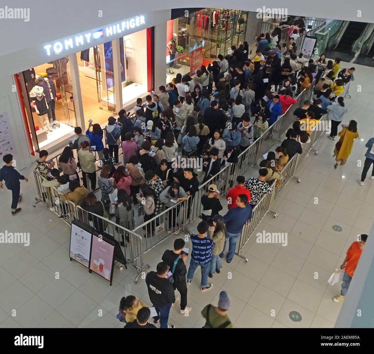 Local citizens, especially the youth, form a long line to buy milk tea ...