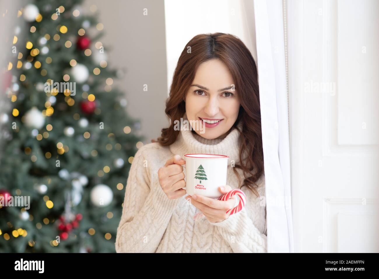 Dark-haired young pretty woman having morning tea Stock Photo - Alamy