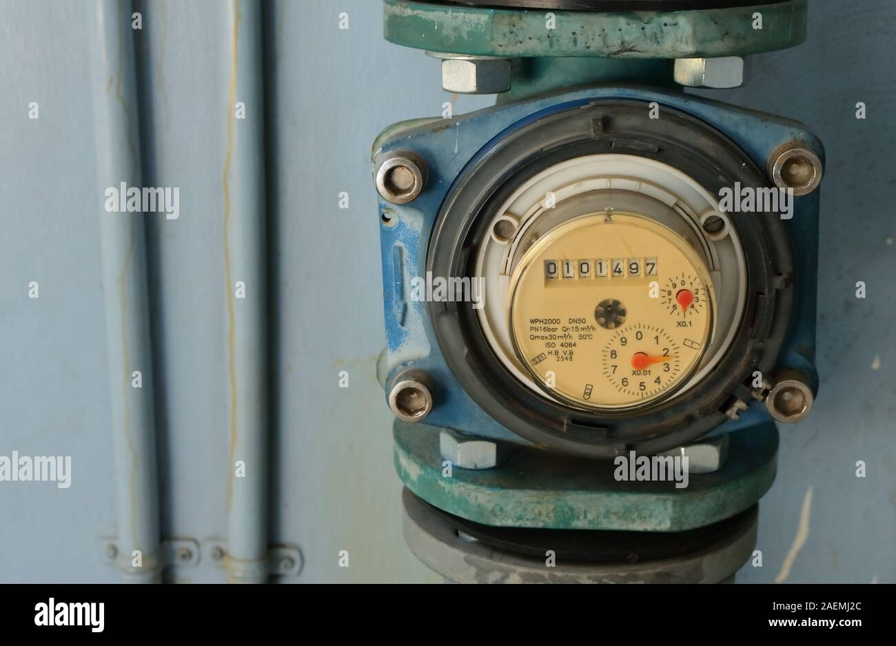 Selective focus of water meter dial connected to the pipe for measuring ...
