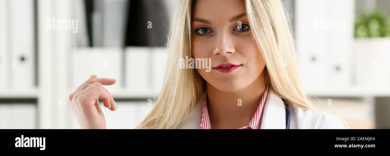 Beautiful smiling female doctor sit at workplace Stock Photo - Alamy