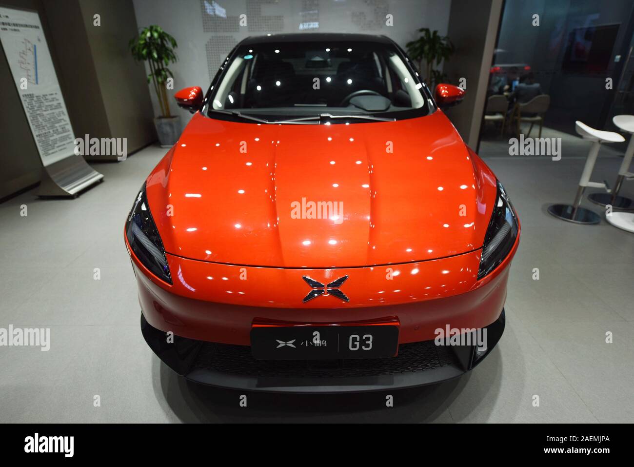 A pedestrian walks past a Xpeng store in Hangzhou city, east China's ...