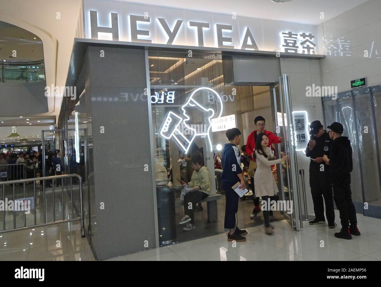 Local citizens, especially the youth, form a long line to buy milk tea ...
