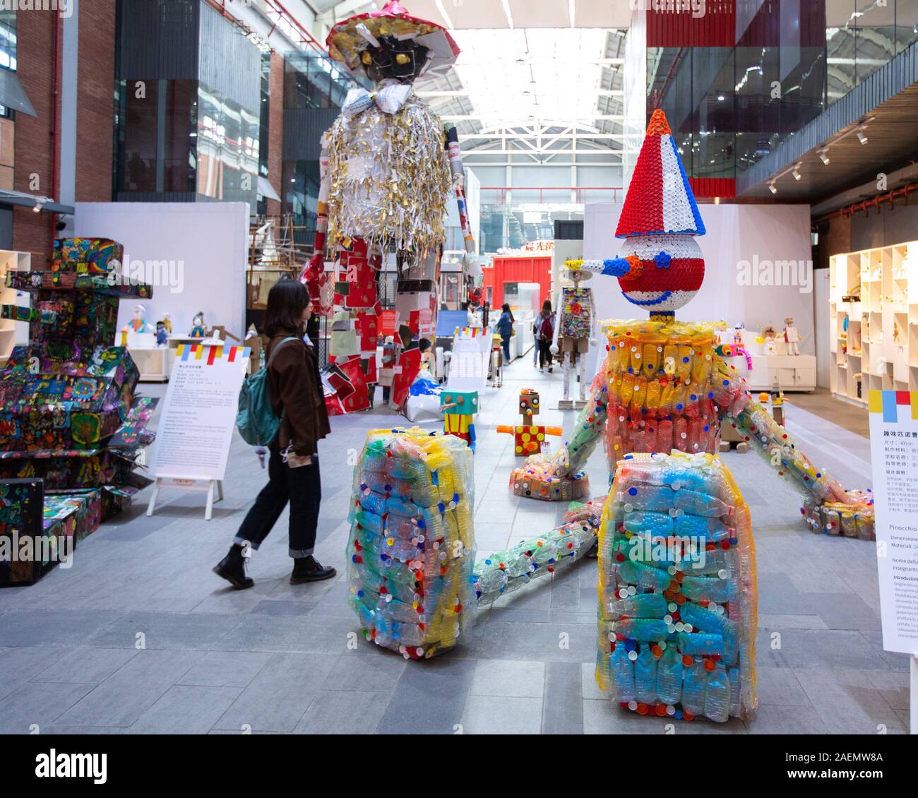 A visitor looks around at the Pinocchio sculptors made from garbage and ...