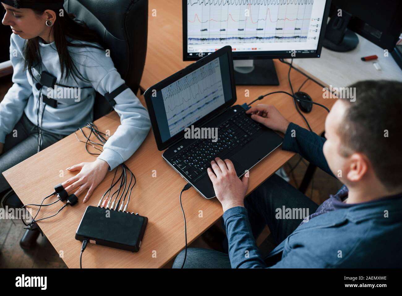 Dishonesty conception. Girl passes lie detector in the office. Asking ...