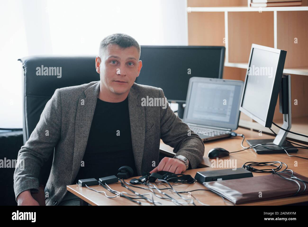 Professional services. Polygraph examiner works in the office with his ...