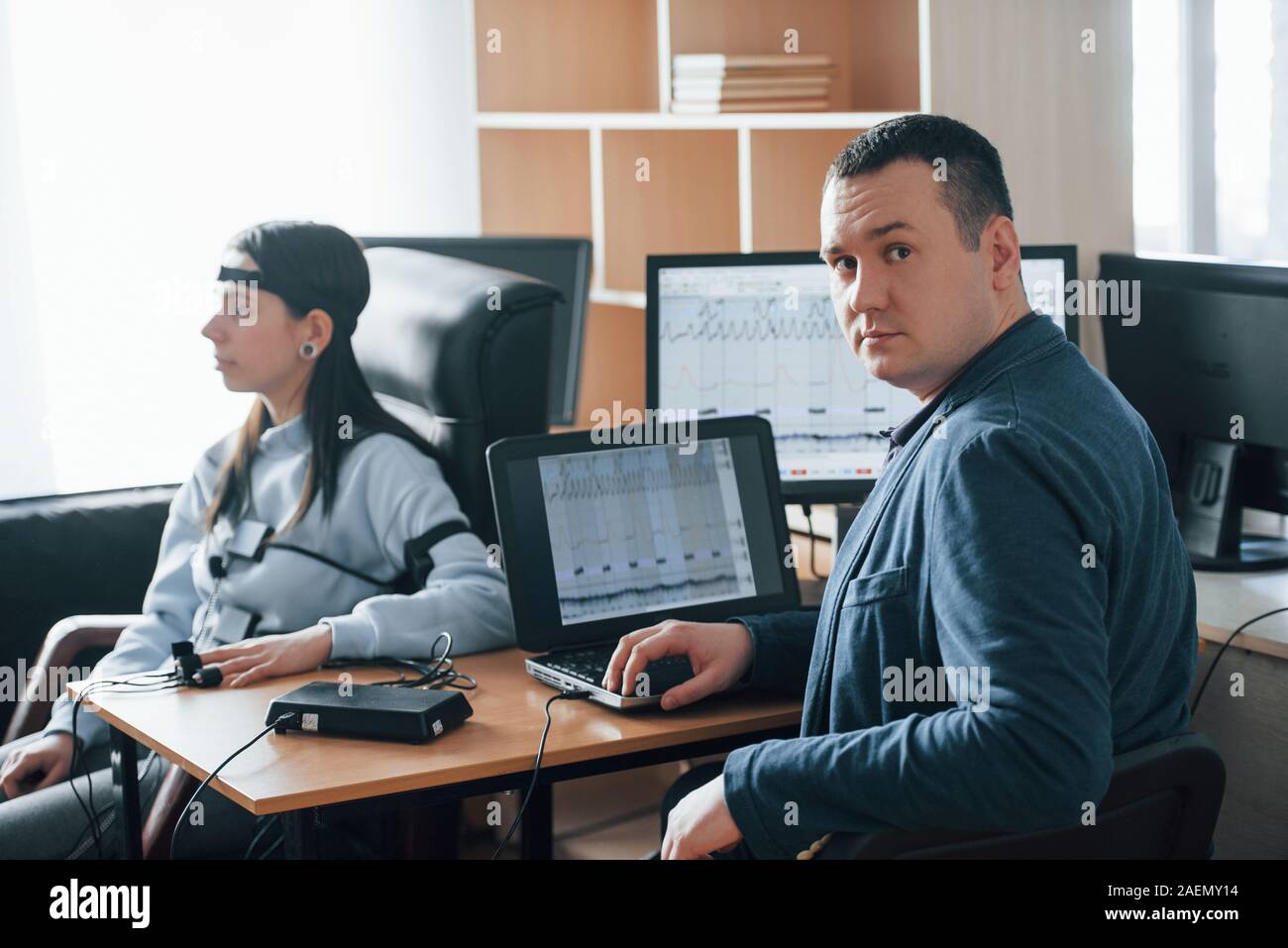 Polygraph testing in progress. Girl passes lie detector in the office ...