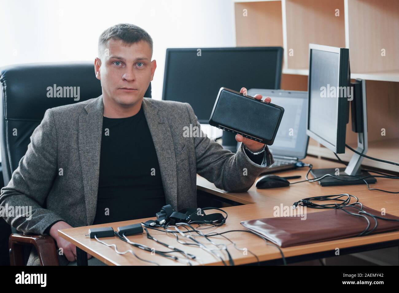 Modern technologies. Polygraph examiner works in the office with his ...