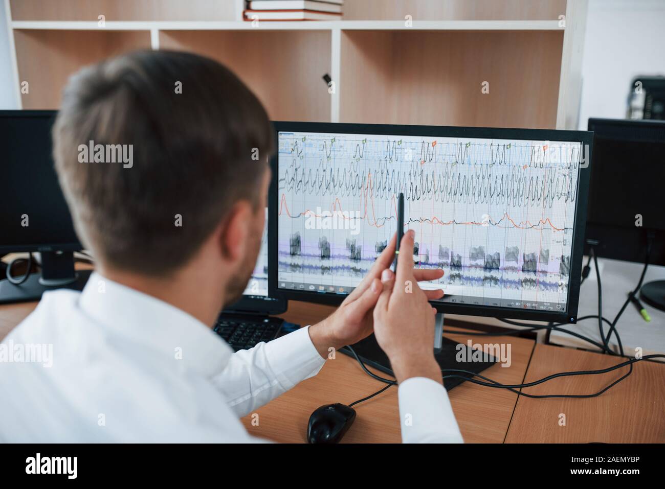 Working process. Polygraph examiner in the office with his lie detector ...