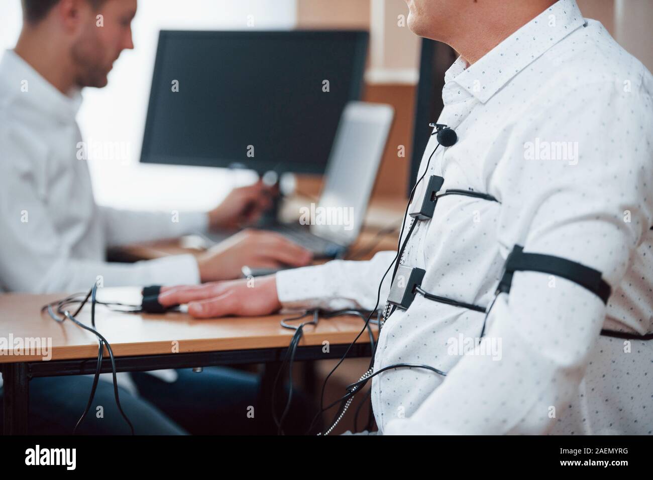 Microphone and sweating sensors. Suspicious man passes lie detector in ...