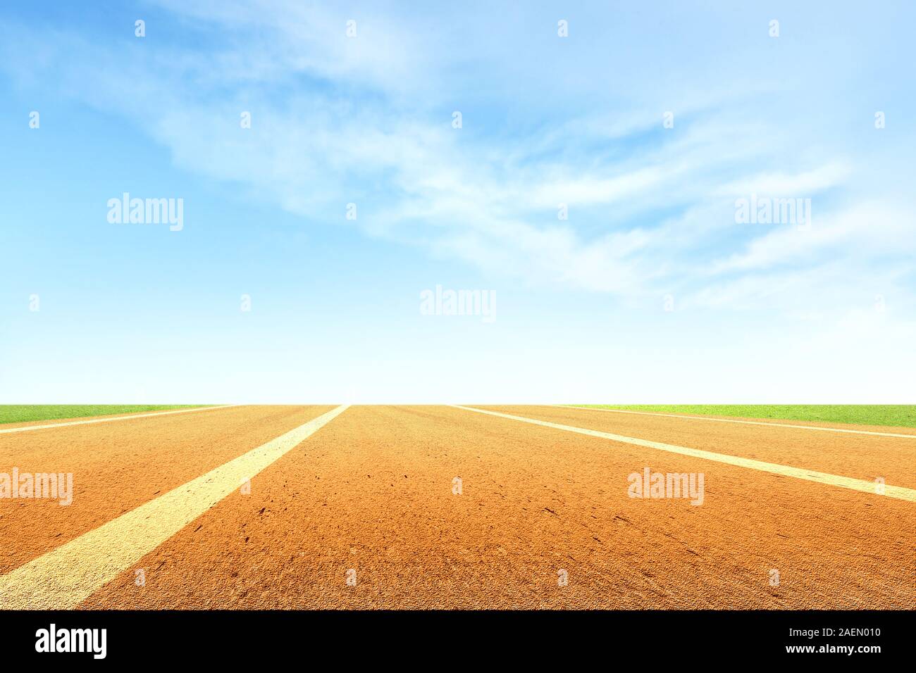Running track with green grass and blue sky background Stock Photo - Alamy