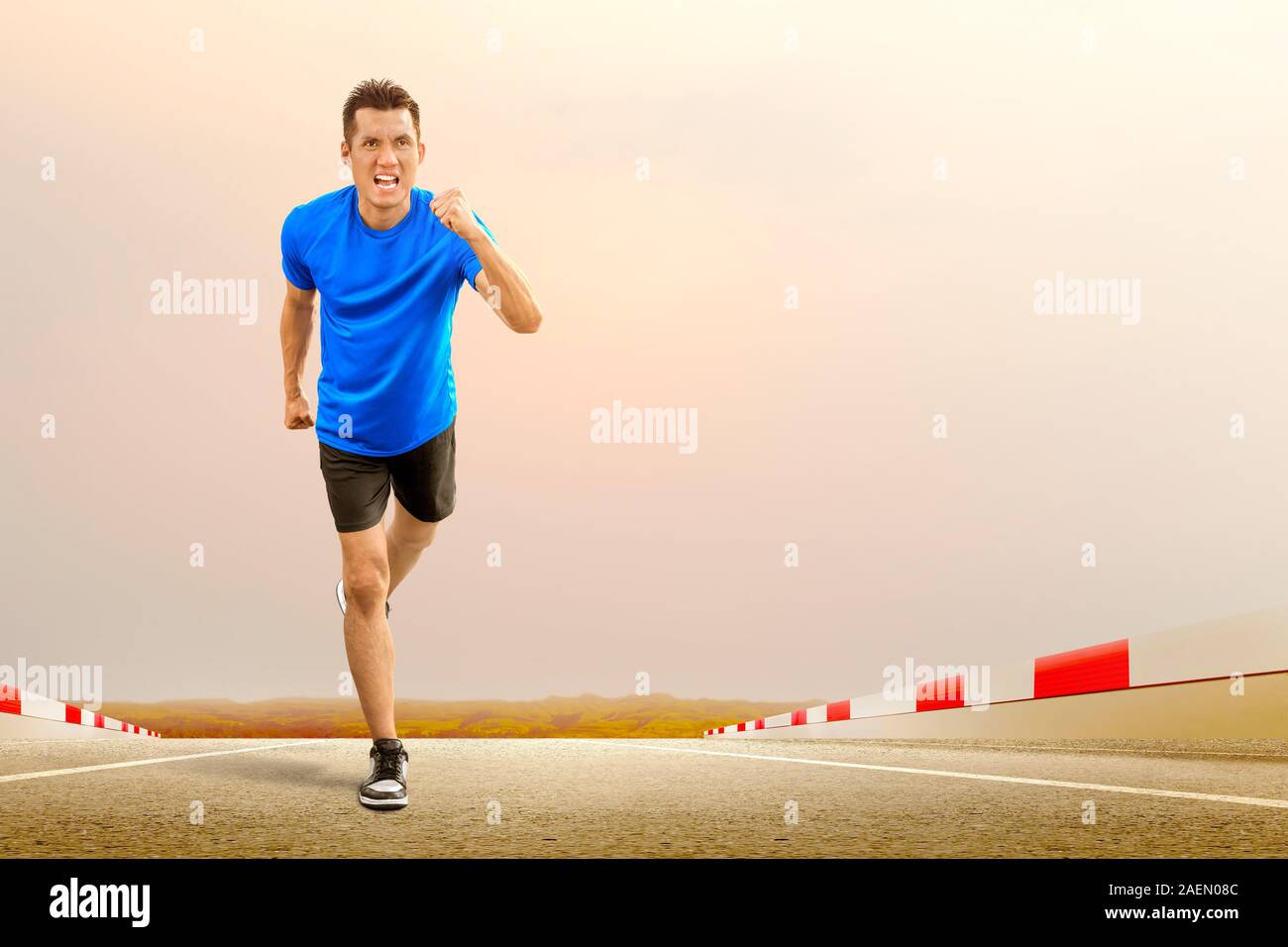 Asian runner man running on the running track with a sky background ...