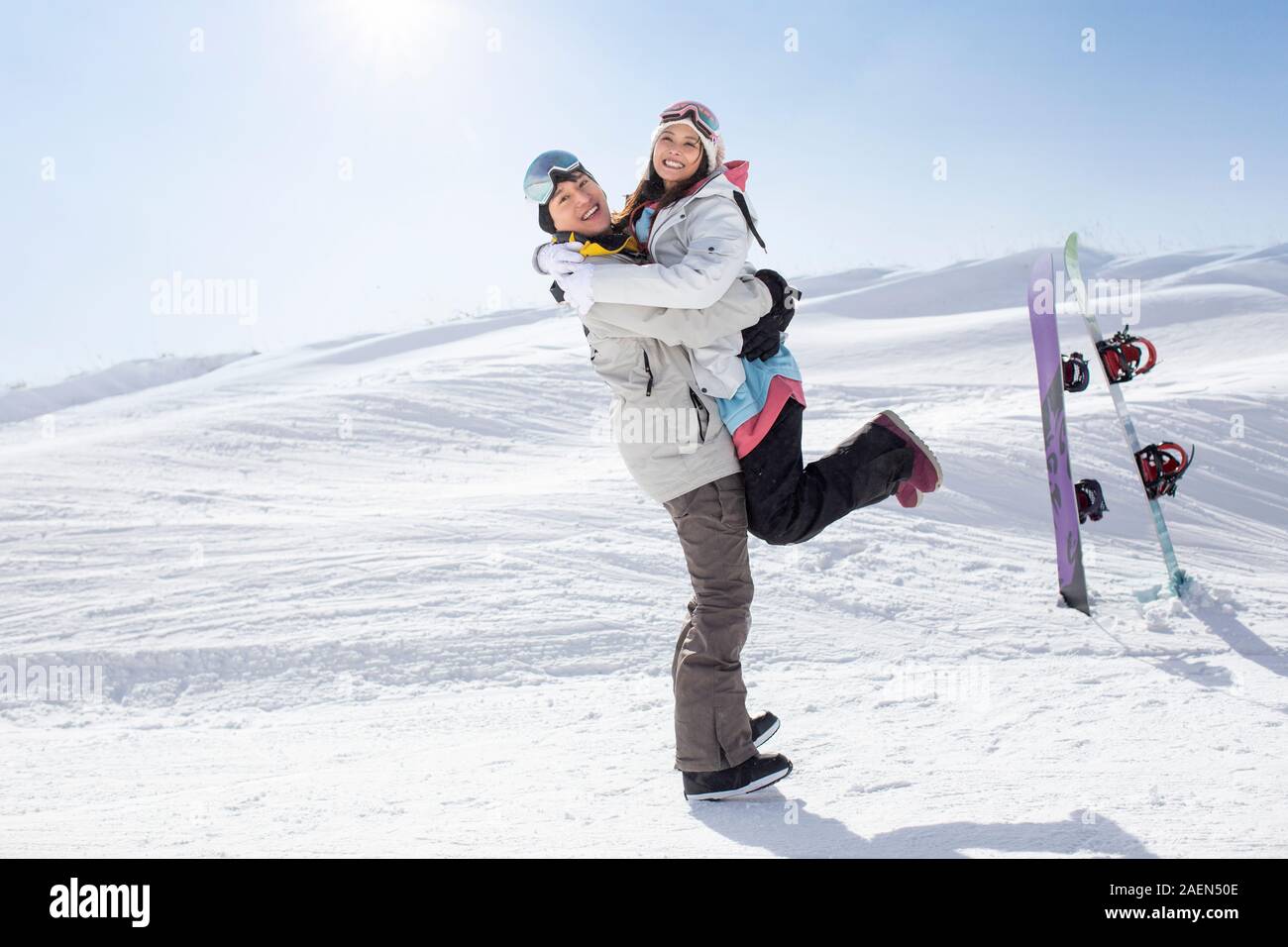 Happy young couple skiing in ski resort Stock Photo - Alamy