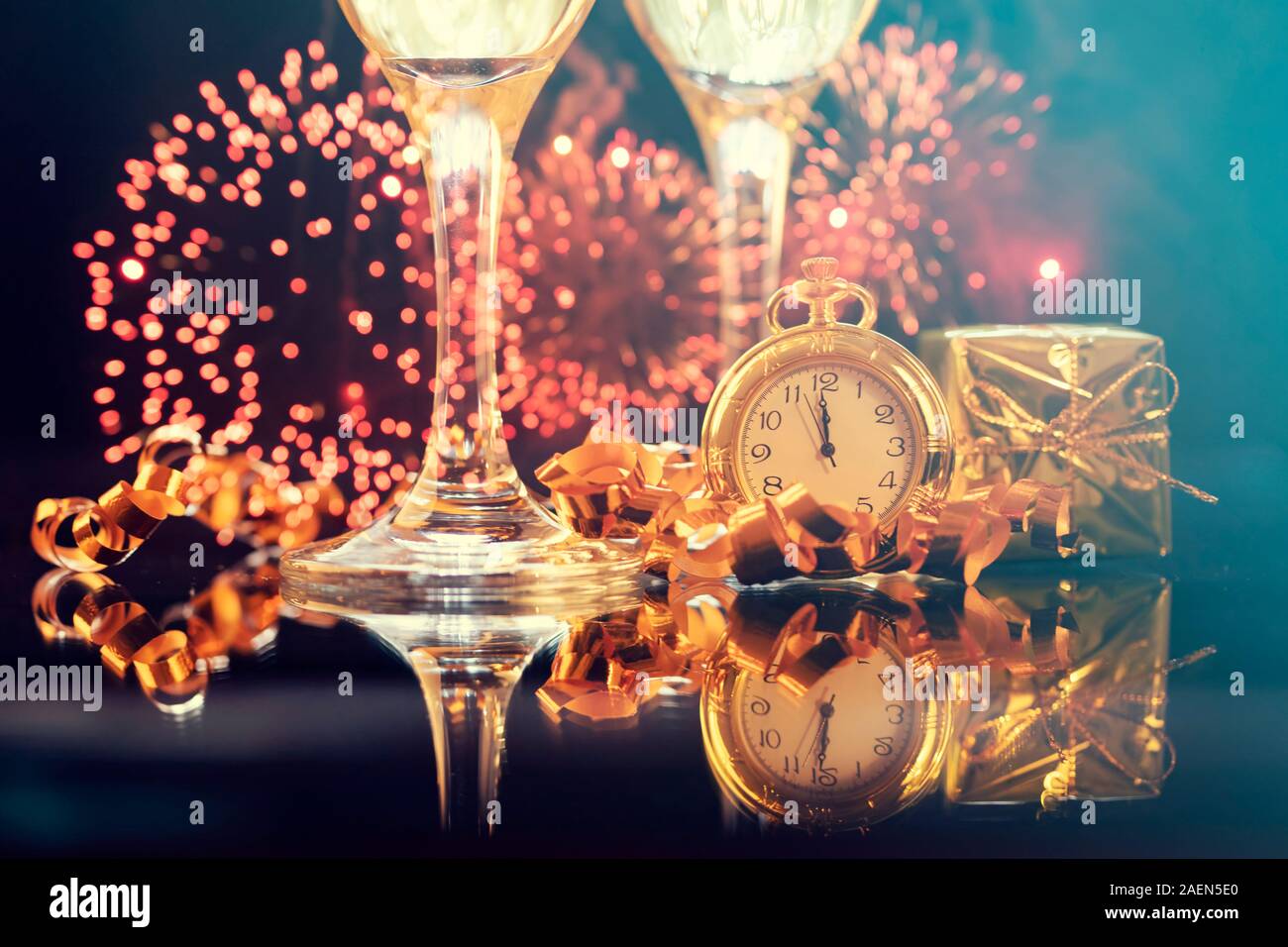 Champagne, clock close to midnight and Christmas decoration on ...