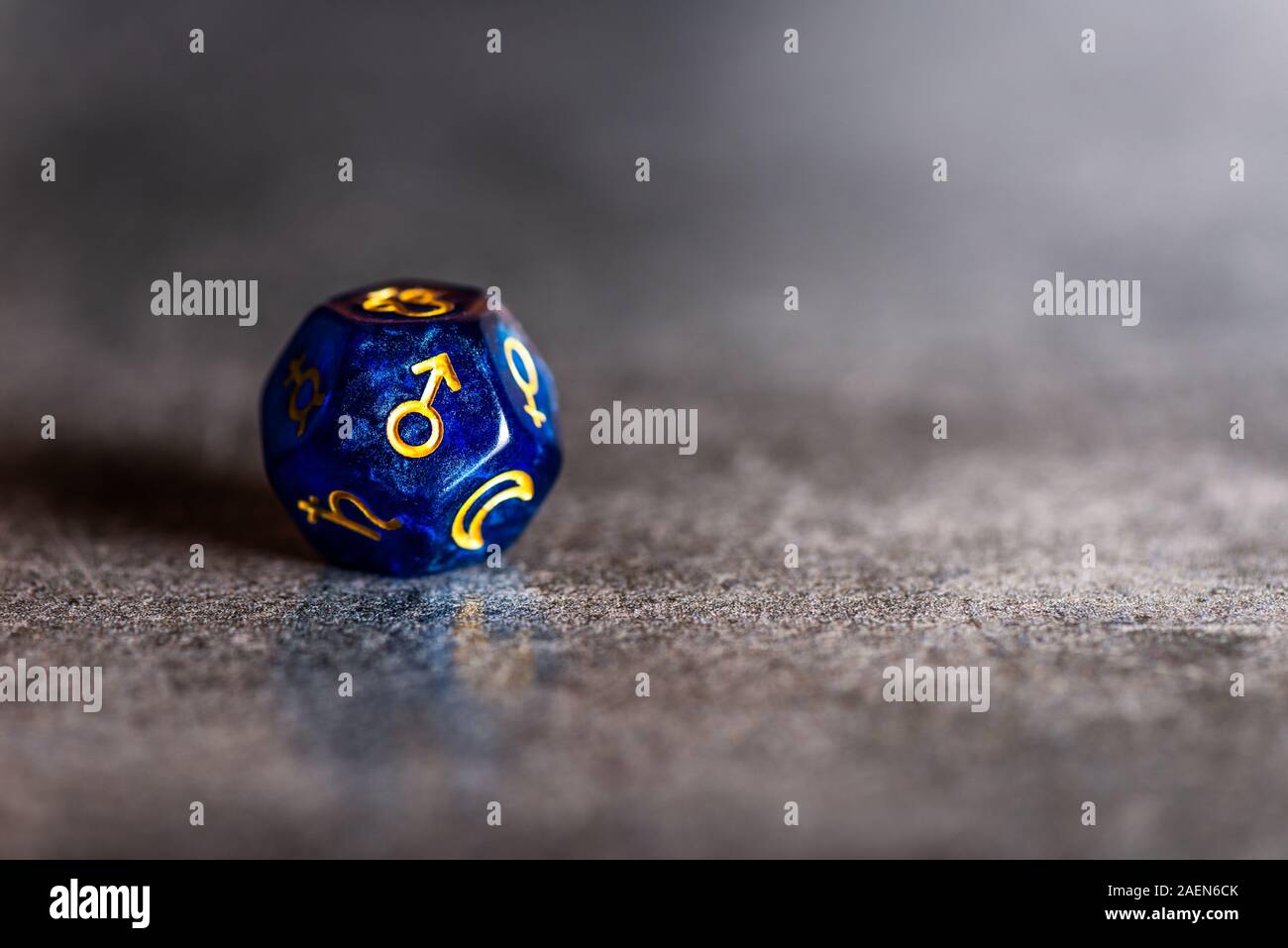 Blue Astrology Dice with symbol of the planet Mars on dark grey ...
