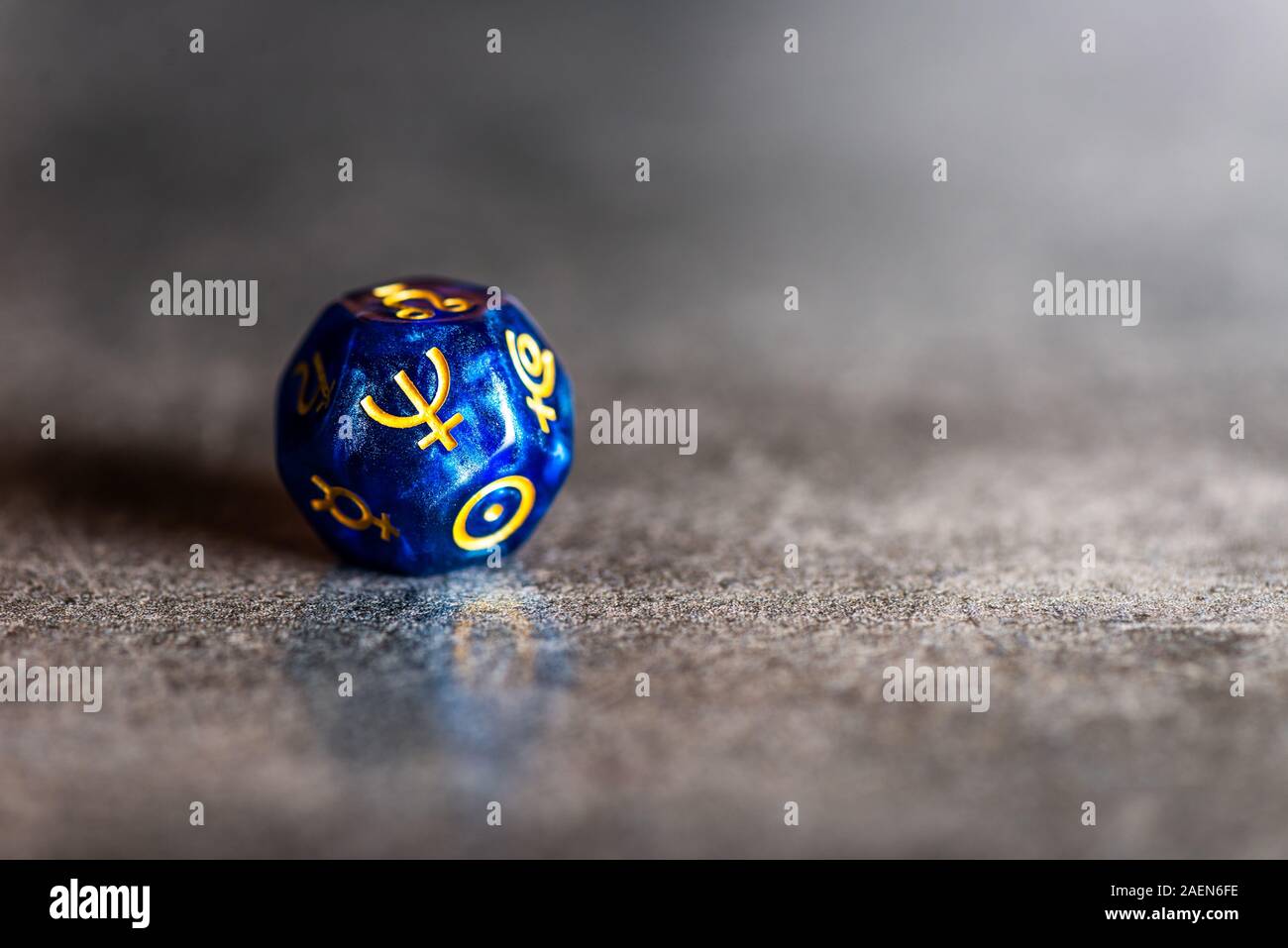 Blue Astrology Dice with symbol of the planet Neptune on grey ...