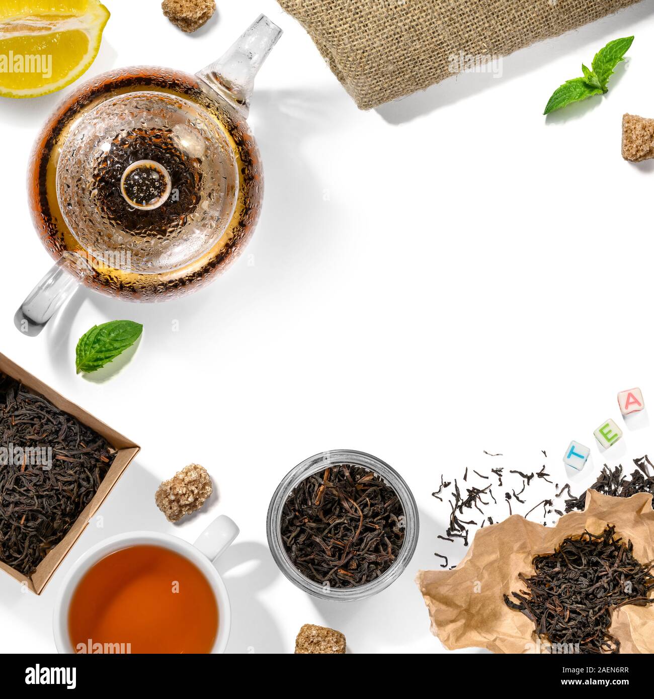 Black tea and accessories top view on white background Stock Photo - Alamy