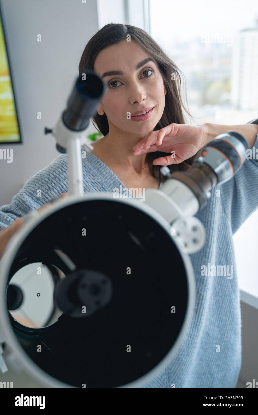 Beautiful astronomer posing with telescope stock photo Stock Photo - Alamy