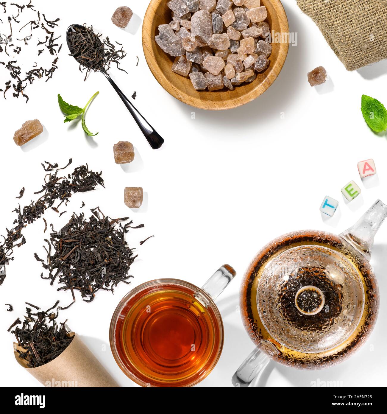 Black tea and accessories top view on white background Stock Photo - Alamy