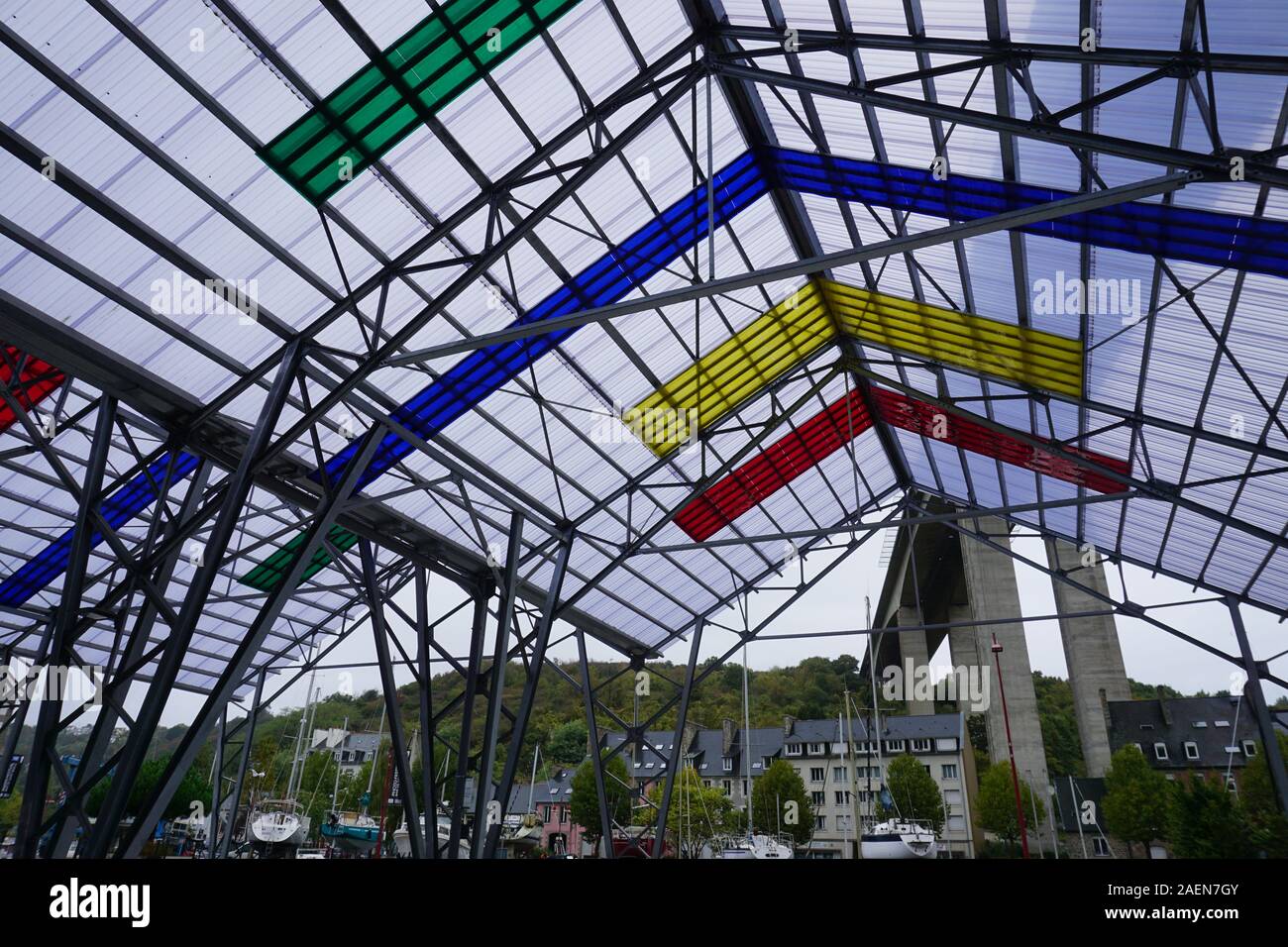colorful roof top with metal structure by an old stone bridge in a ...