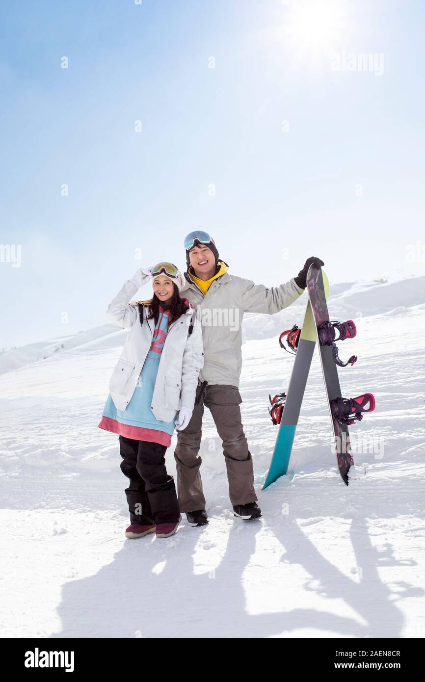 Happy young couple skiing in ski resort hi-res stock photography and ...