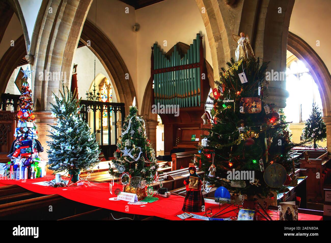 Decorated Christmas trees at village church Christmas Tree Festival in ...