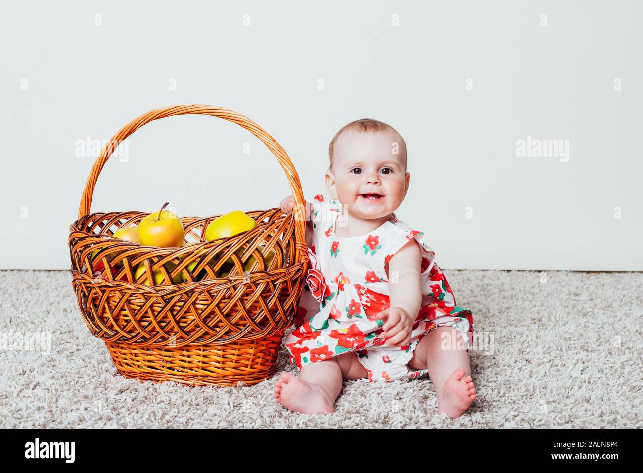 baby girl with a basket of Green apples Stock Photo - Alamy