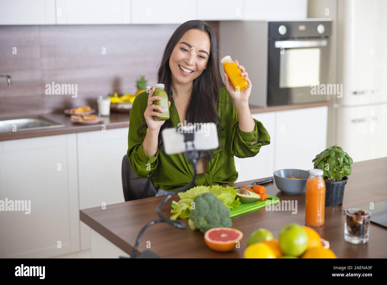 Cheerful woman boasting of her organic sauces Stock Photo - Alamy