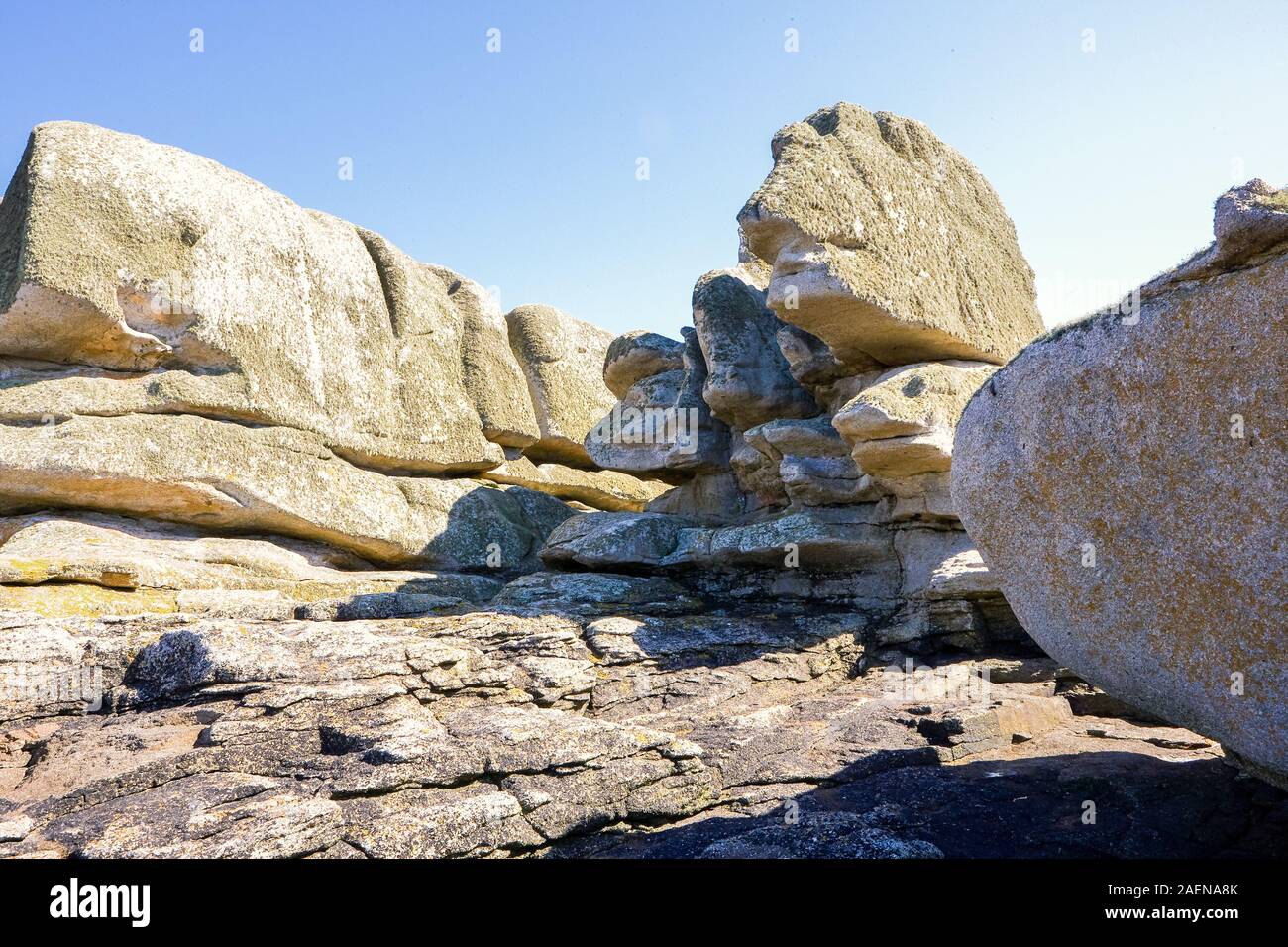 Big special rock formation at the coast of Brittany, blue sky, sunlight ...