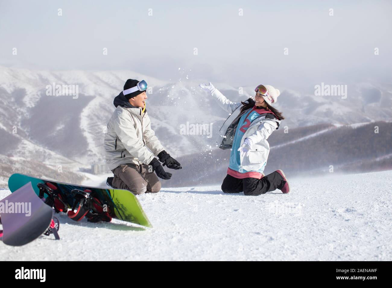 Young couple throwing snow in hi-res stock photography and images - Alamy