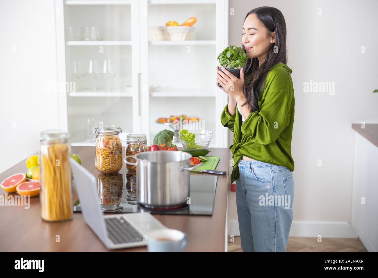 Blissful cook with eyes closed standing indoors Stock Photo - Alamy