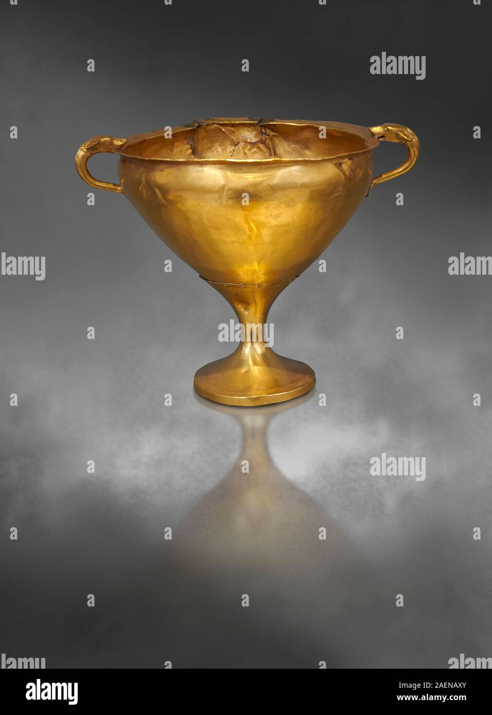 Mycenaean gold goblet with two handles ening with a dogs head biting ...