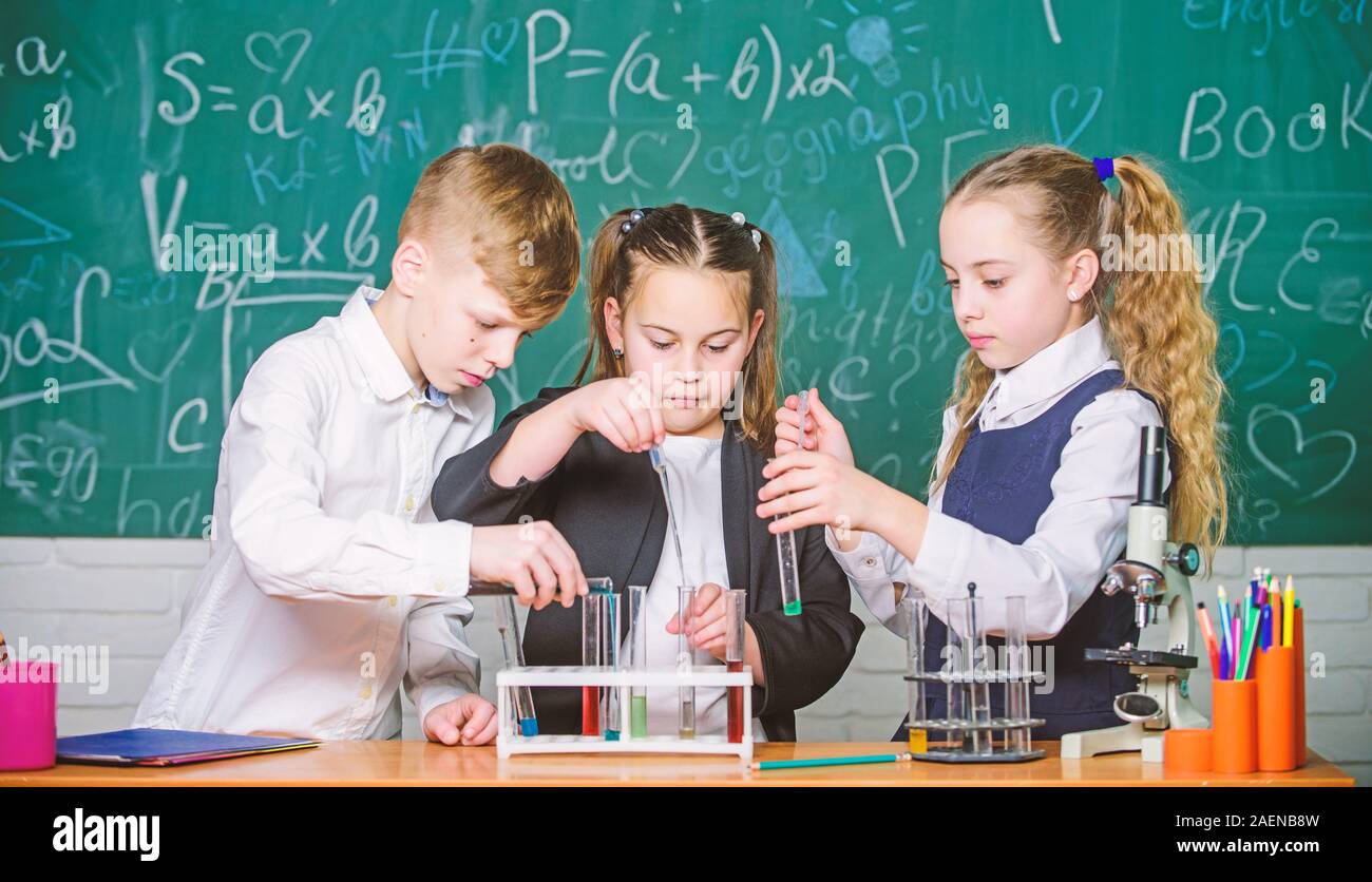 Little kids learn chemistry in school lab. students do biology ...