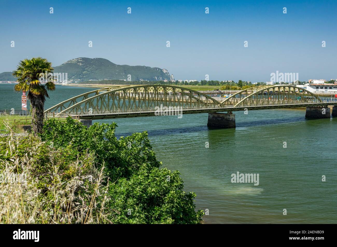 Old vintage iron bridge over the green river Stock Photo - Alamy